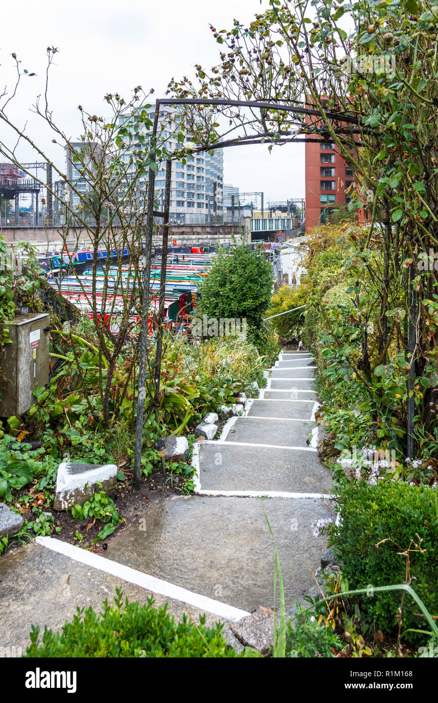 Steps down to the narrowboats moored in the basin at St. Pancras Lock ...