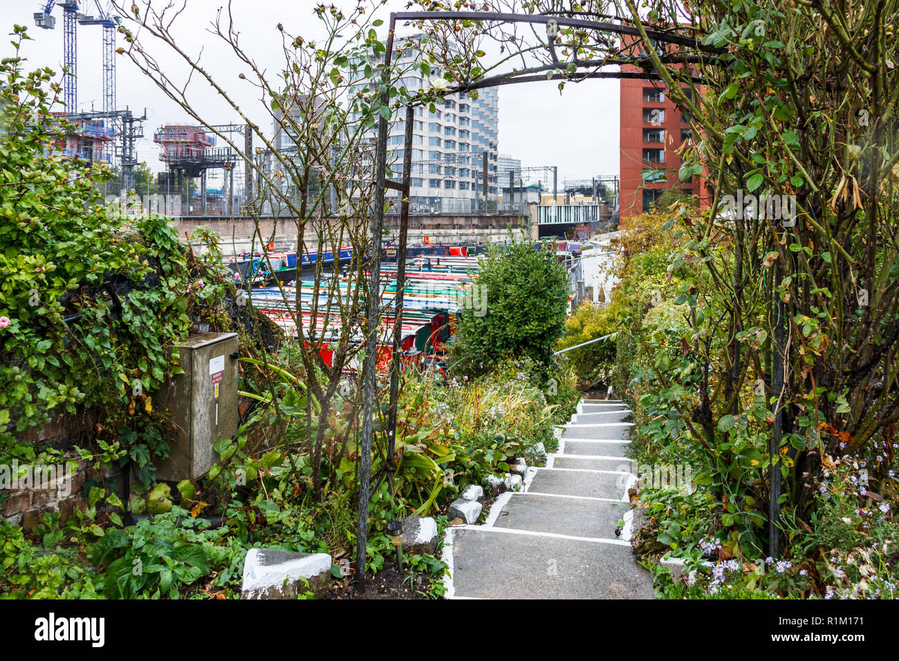 Steps down to the narrowboats moored in the basin at St. Pancras Lock ...