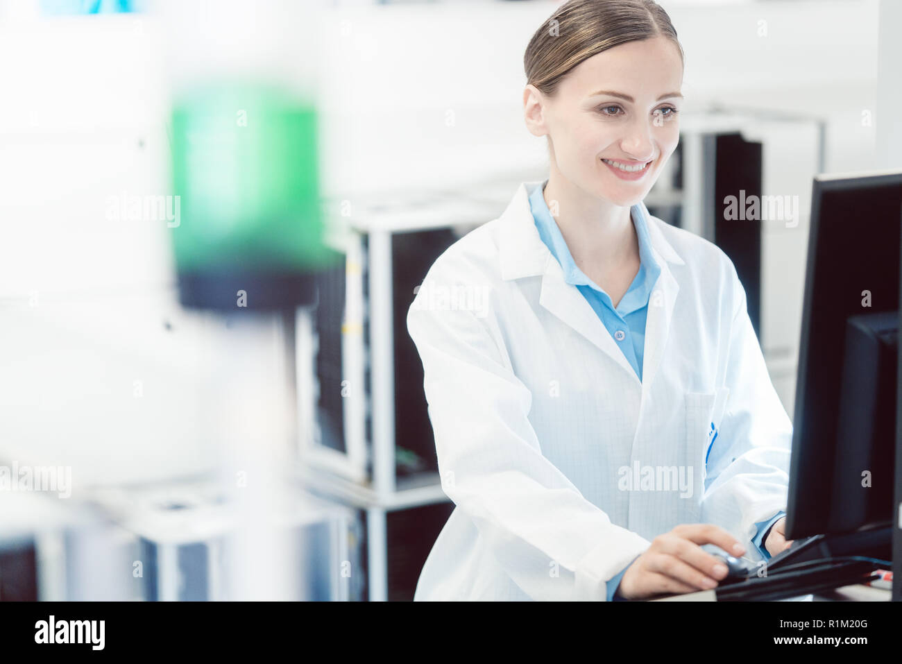 Engineer operating manufacturing line at computer console in ...
