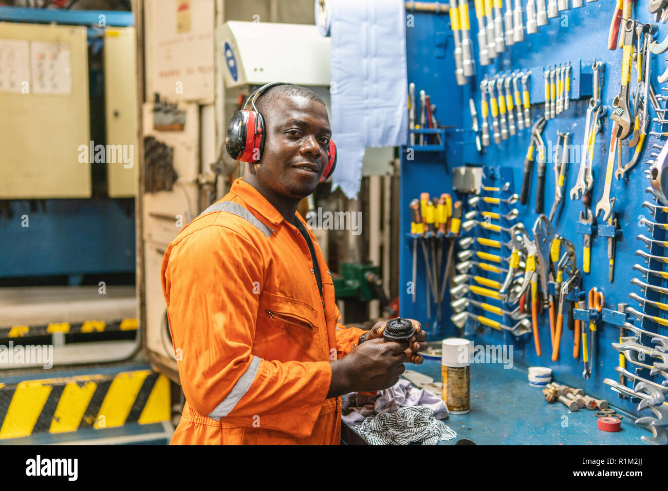 Marine engineer officer working in engine room Stock Photo - Alamy
