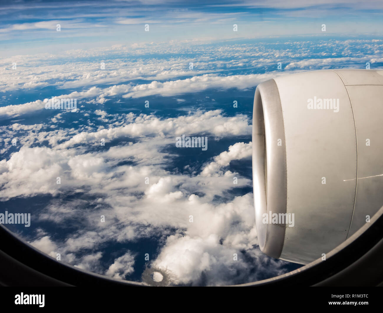 Airplane window during flight with engine, clouds and horizon view ...