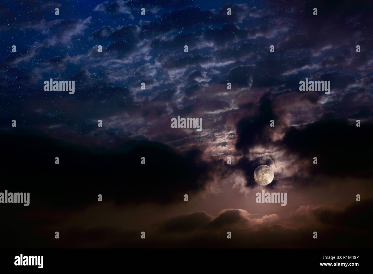 Arising full moon in a cloudy beginning of night Stock Photo - Alamy