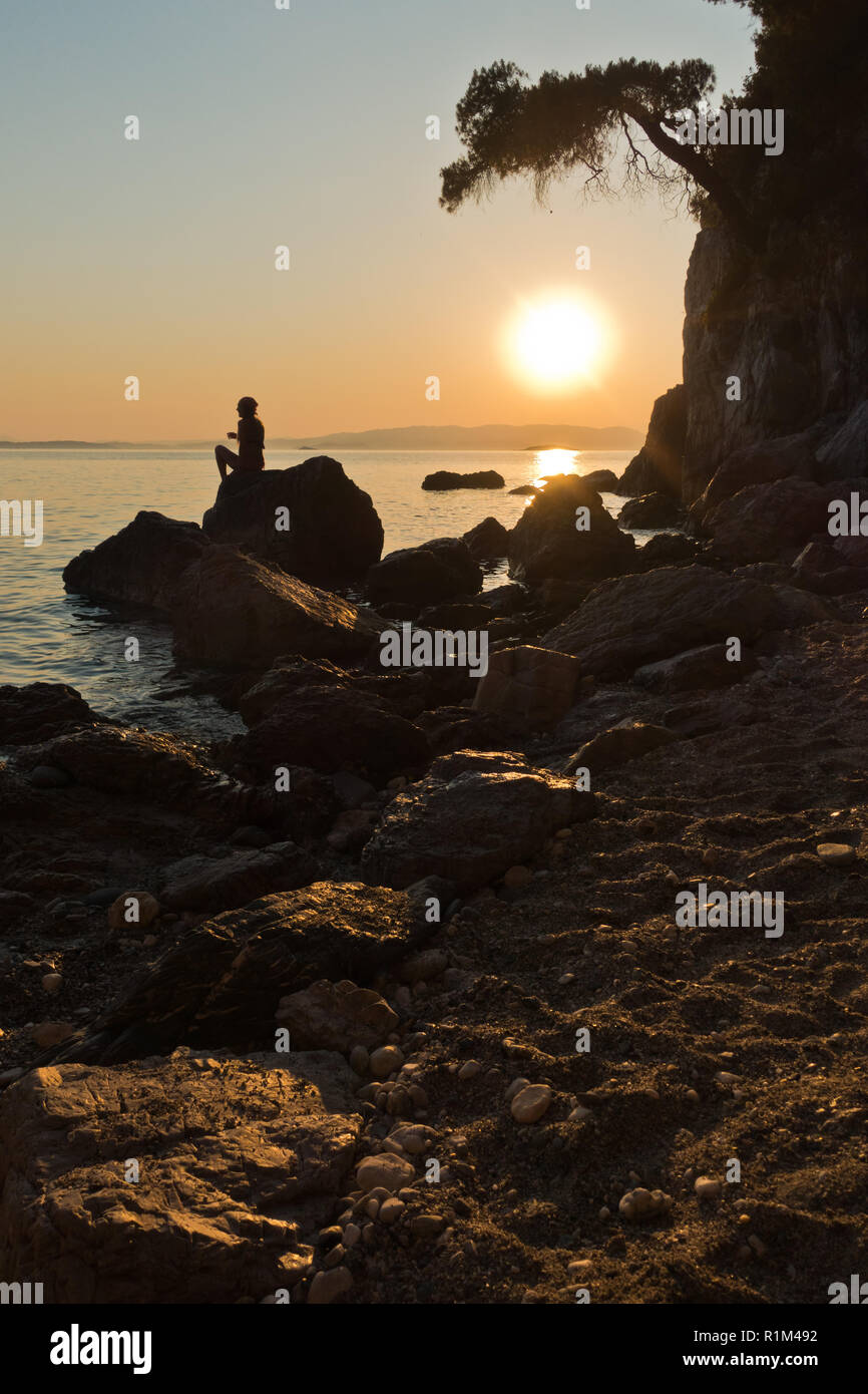 Silhouette woman sitting on rock hi-res stock photography and images ...