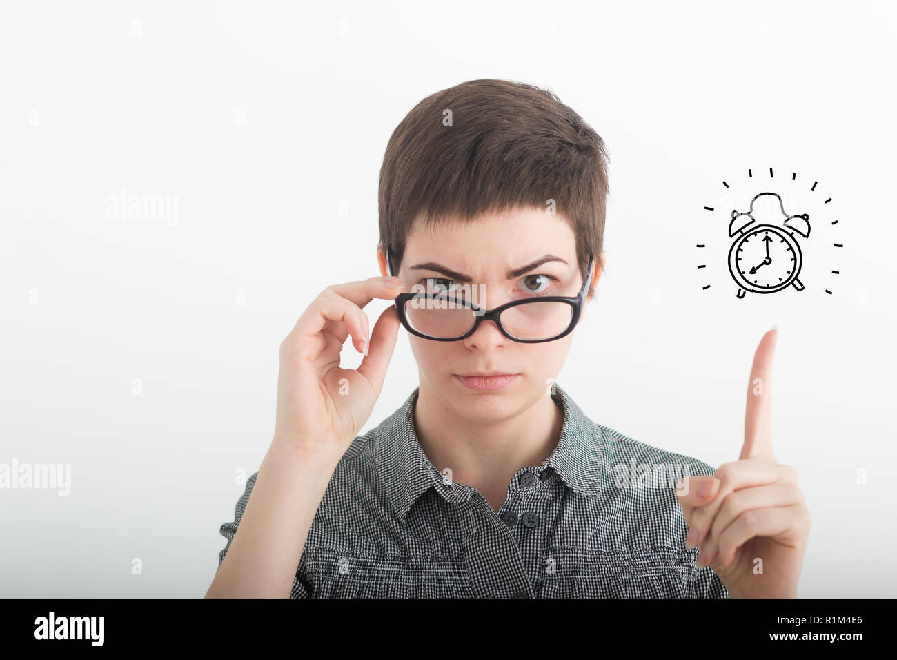 Young strict irritated business woman in glasses pointing index finger ...