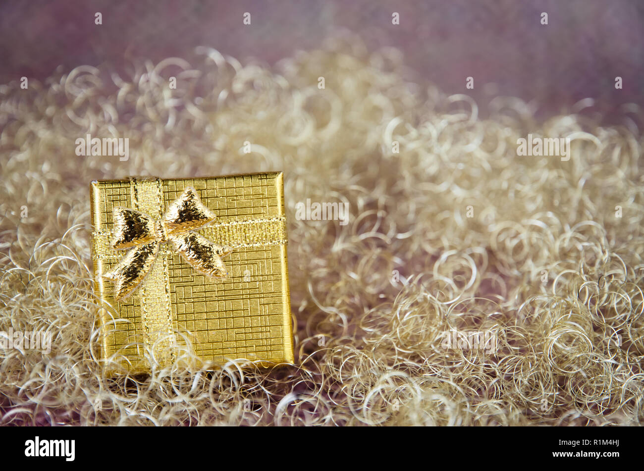 shining golden christmas box with surprise inside in silver background ...