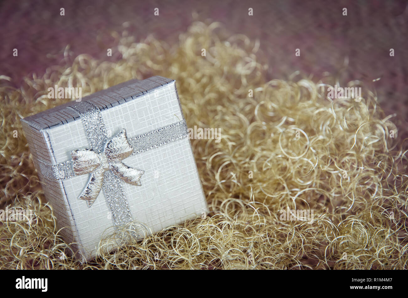 shining silver christmas box with surprise inside in silver background ...