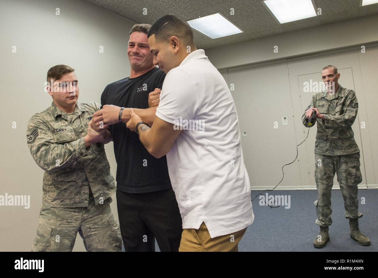 Josh Eldridge, second left, a police officer with the 673d Security ...