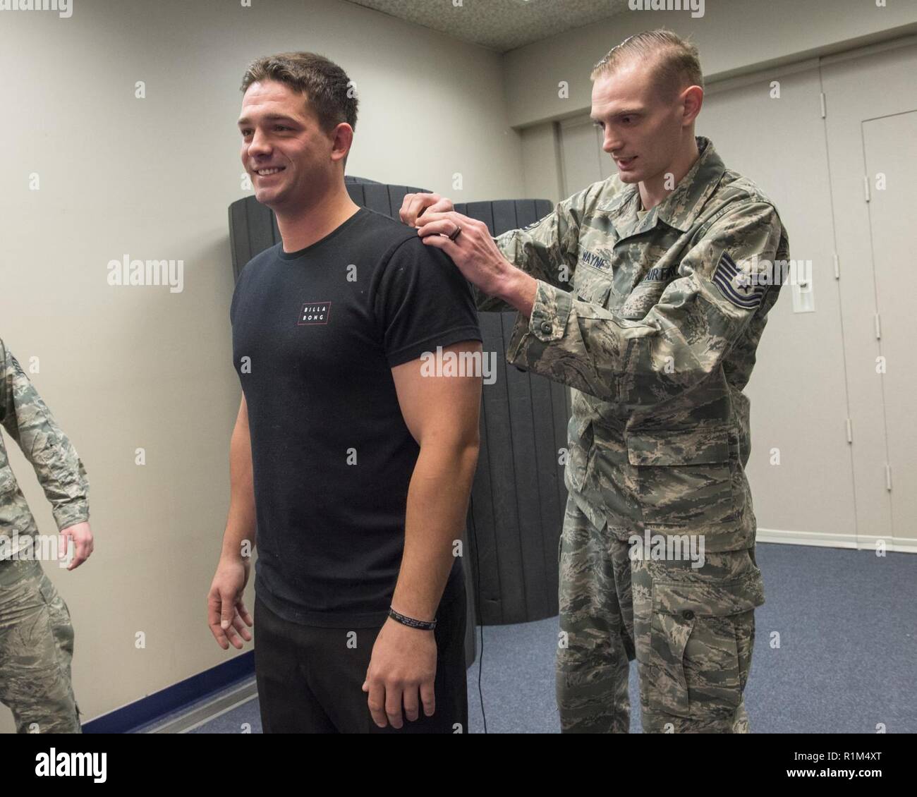 U.S. Air Force Tech. Sgt. Kristopher Wayne, right, attaches a Taser ...