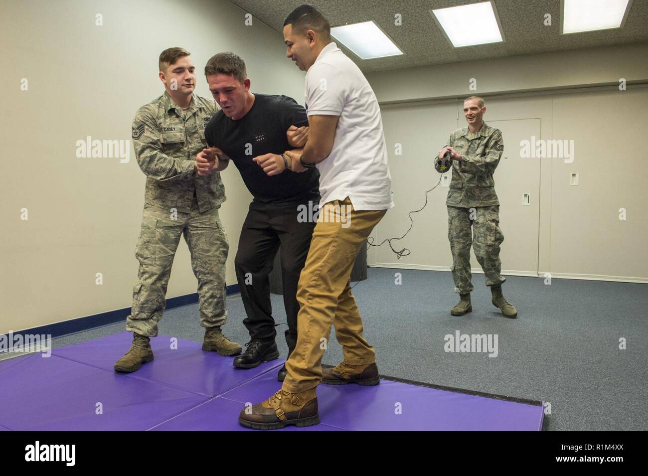 Josh Eldridge, second left, a police officer with the 673d Security ...
