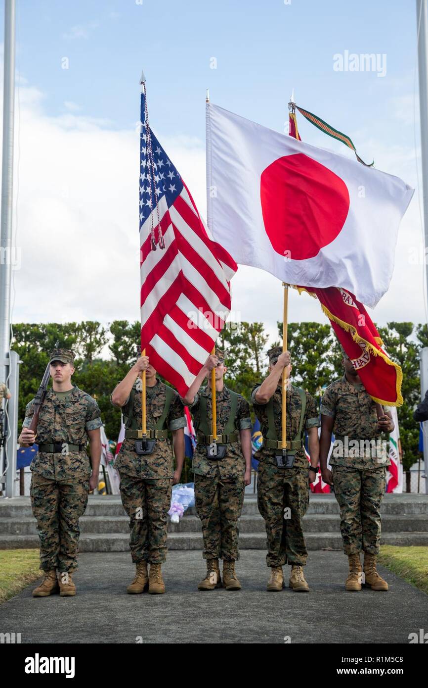 U.S. Marines carry the American, Japanese, and Marine Corps colors ...