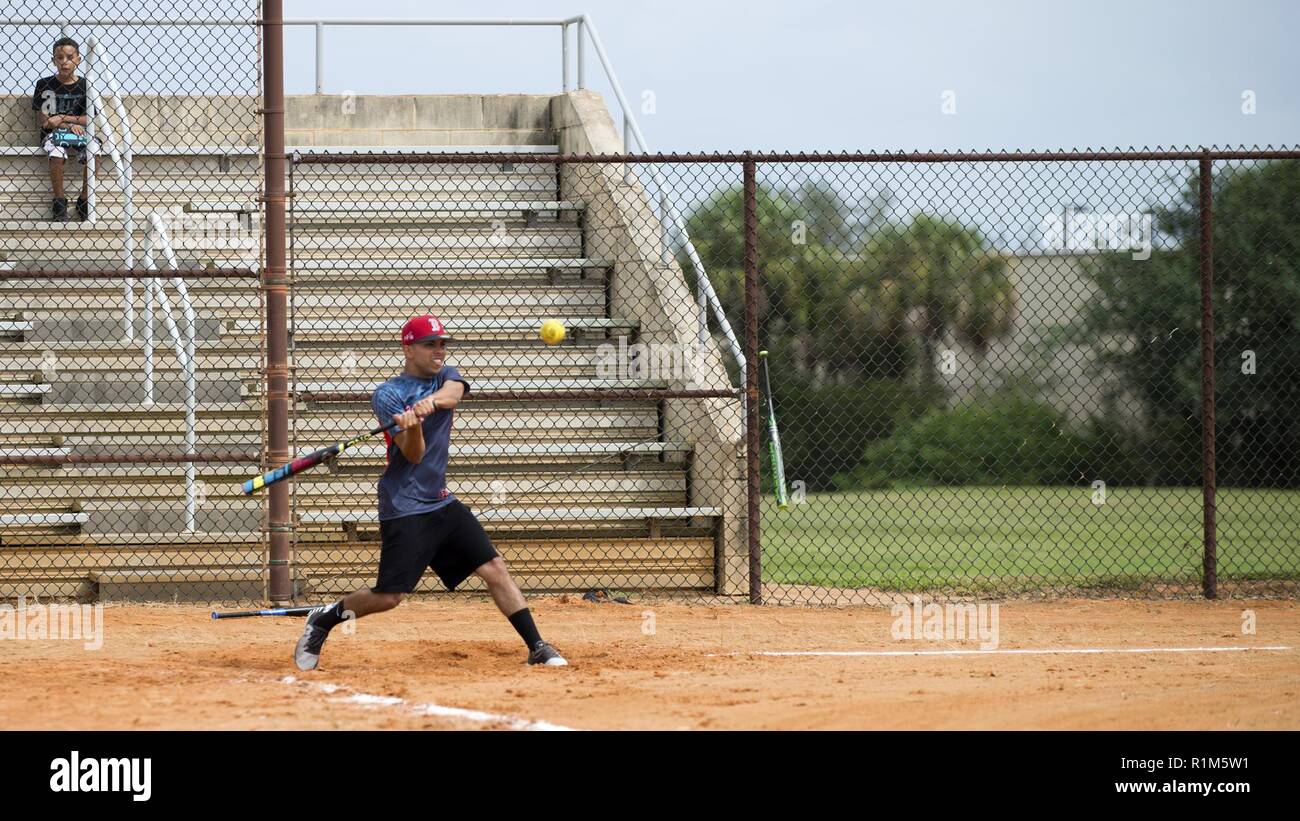 A 6th Civil Engineer Squadron fire protection Airmen swings a bat at ...