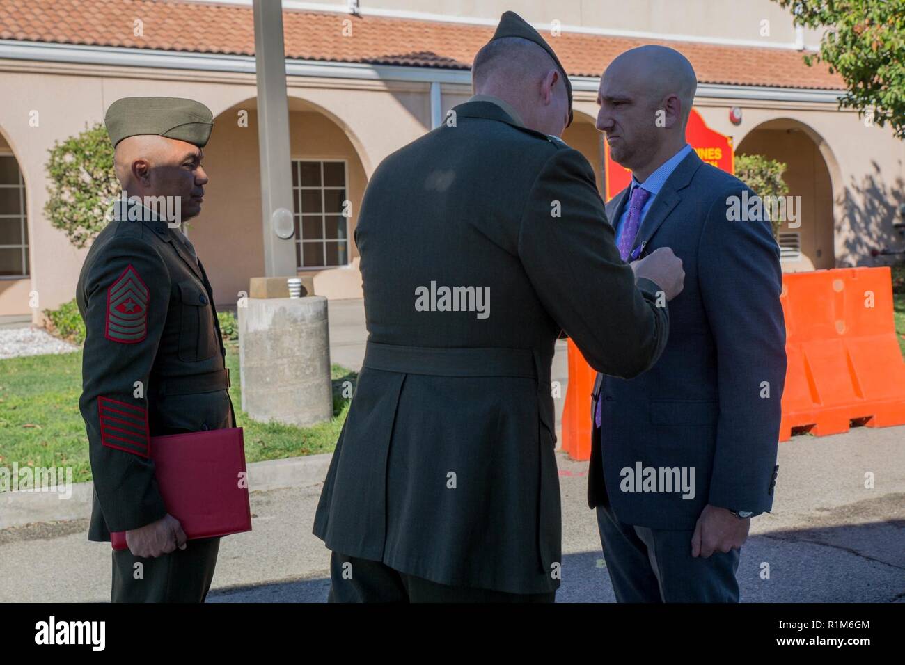 Marine veteran Matthew R. Follett (right), is presented with the Purple ...