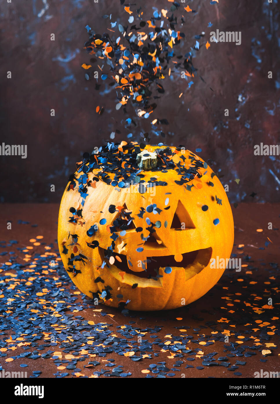 Halloween carved squash and confetti. Dark Holiday spooky background ...