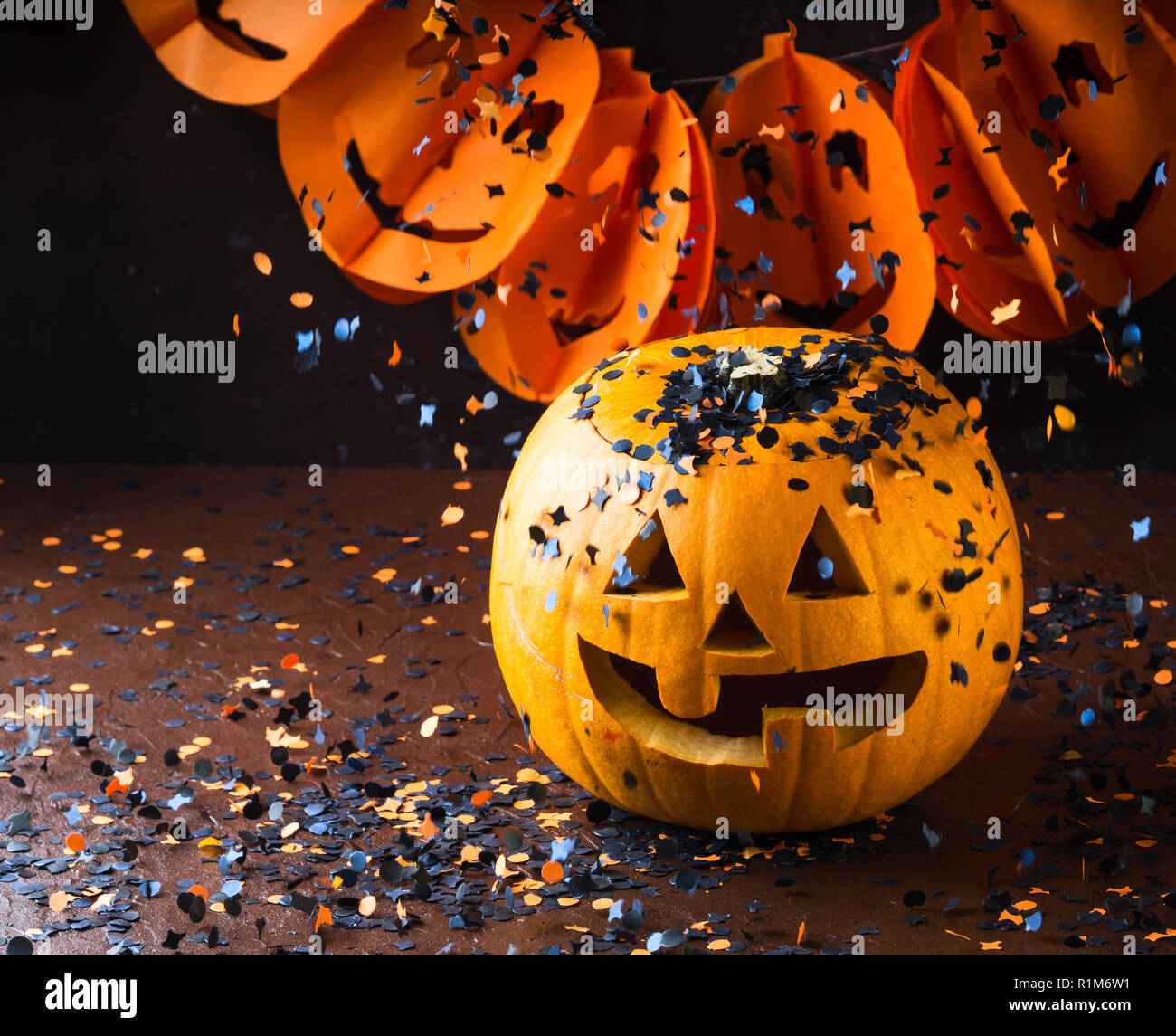 Halloween carved squash and confetti. Dark Holiday spooky background ...