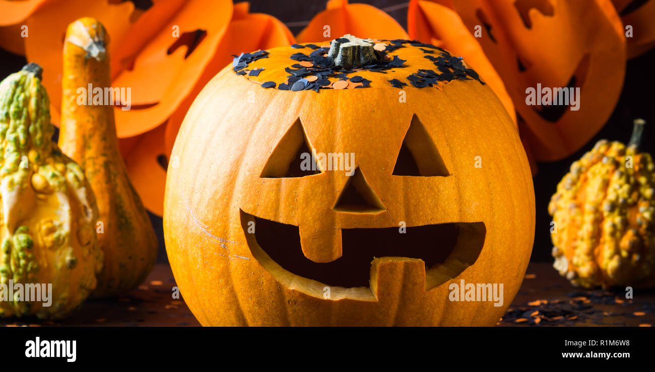 Halloween carved squash and confetti. Dark Holiday spooky background ...