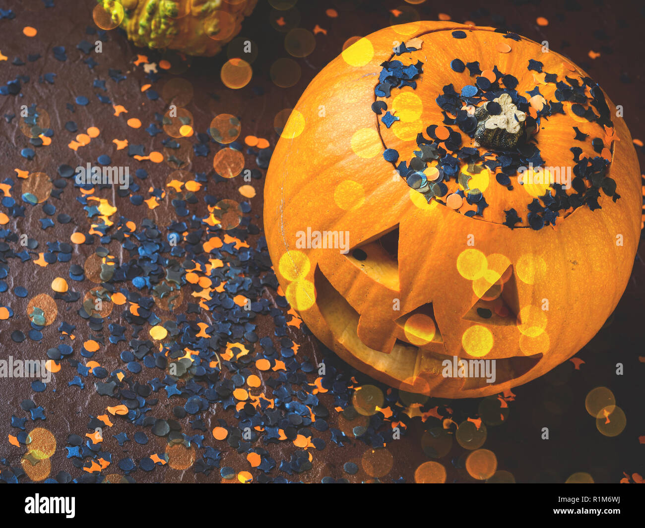 Halloween carved squash and confetti. Dark Holiday spooky background ...