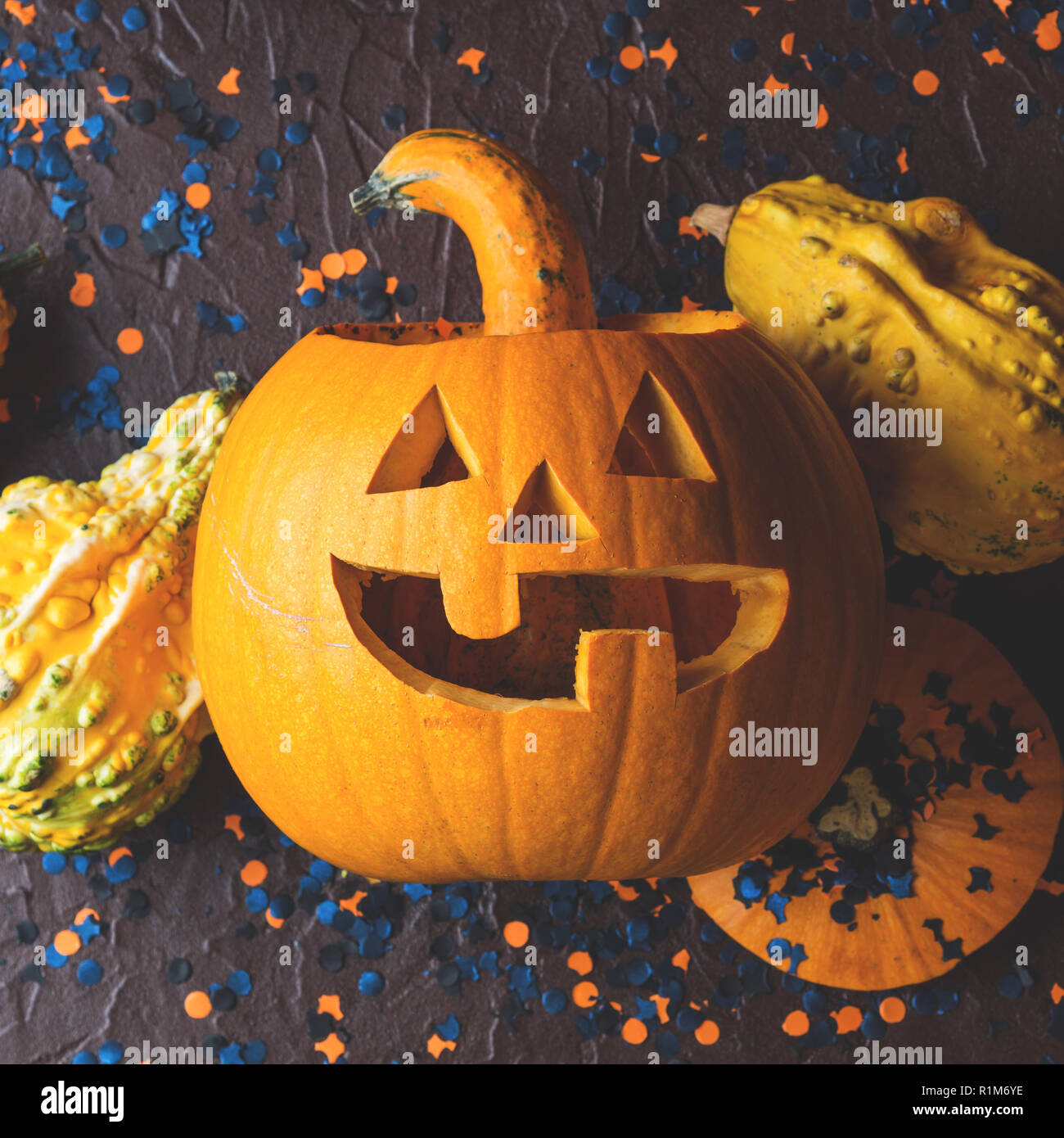 Halloween carved squash and confetti. Dark Holiday spooky background ...