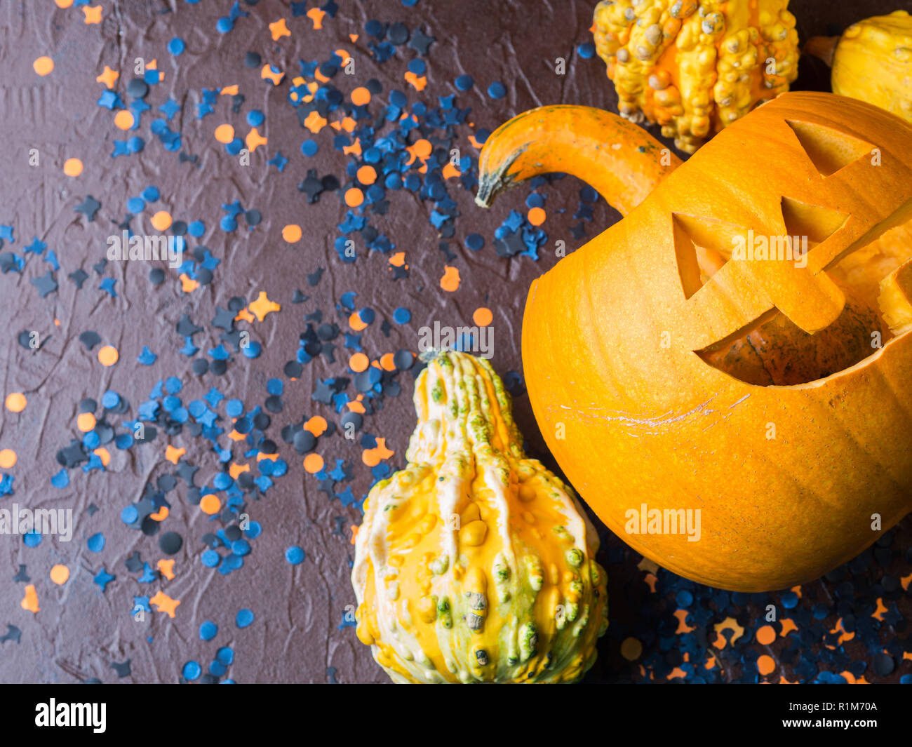 Halloween carved squash and confetti. Dark Holiday spooky background ...