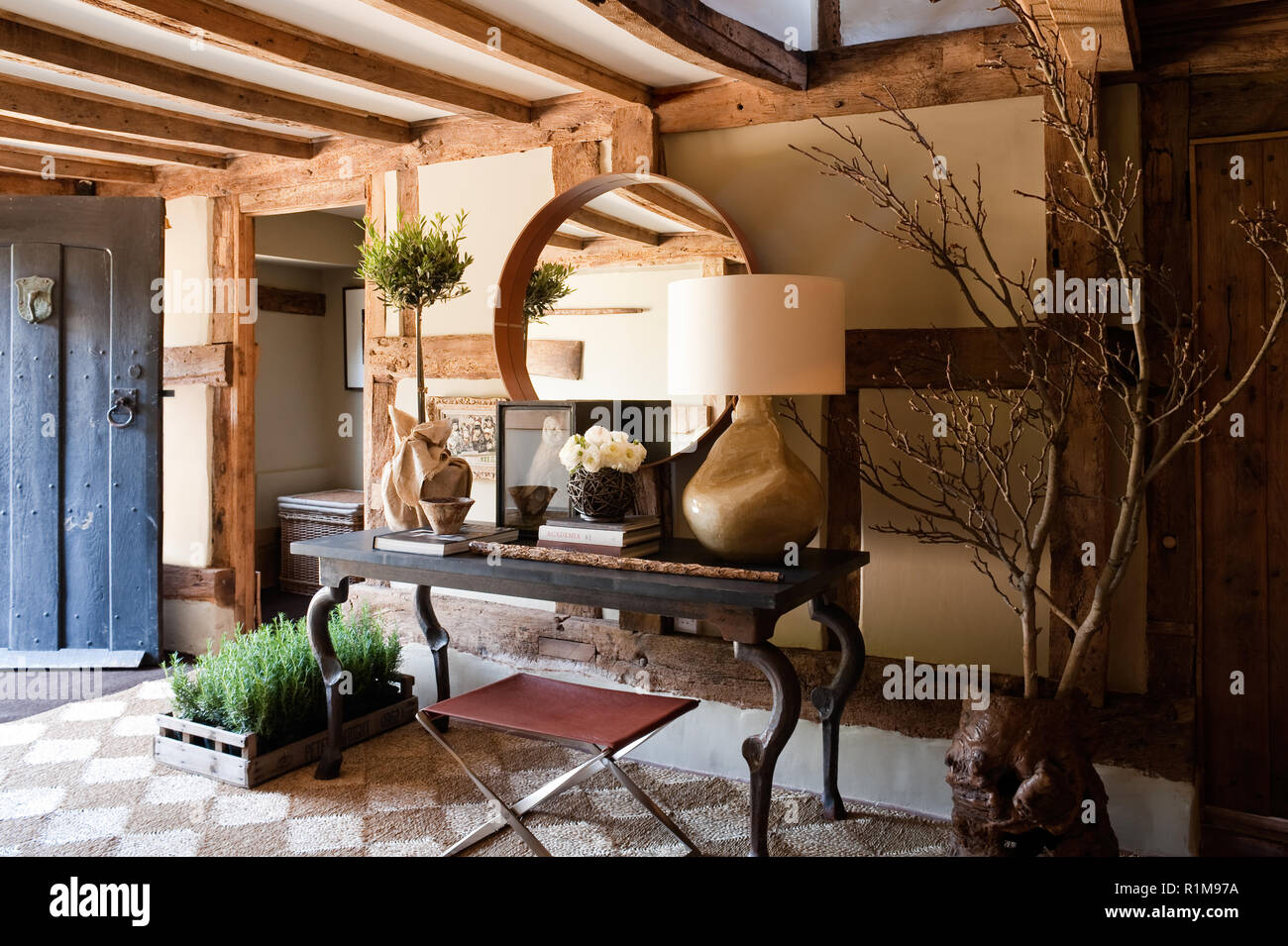 Table in rustic entrance hall Stock Photo - Alamy
