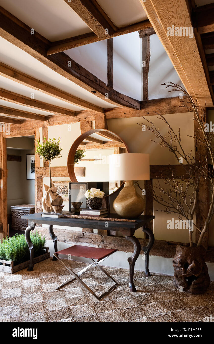 Table in rustic entrance hall Stock Photo - Alamy