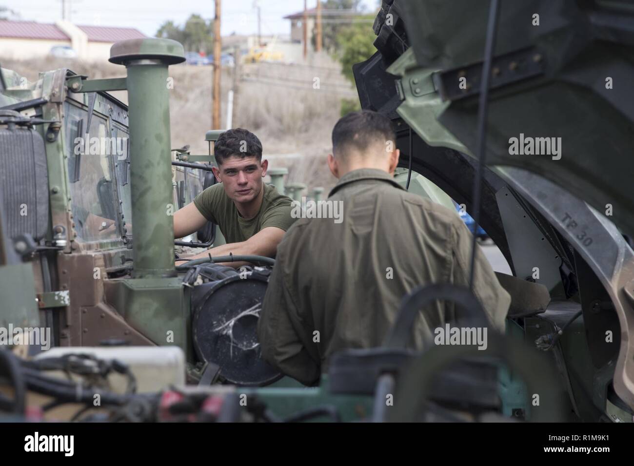 U.S. Marine Corps Pfc. Jaime Ayuso (left), motor vehicle operator, and ...