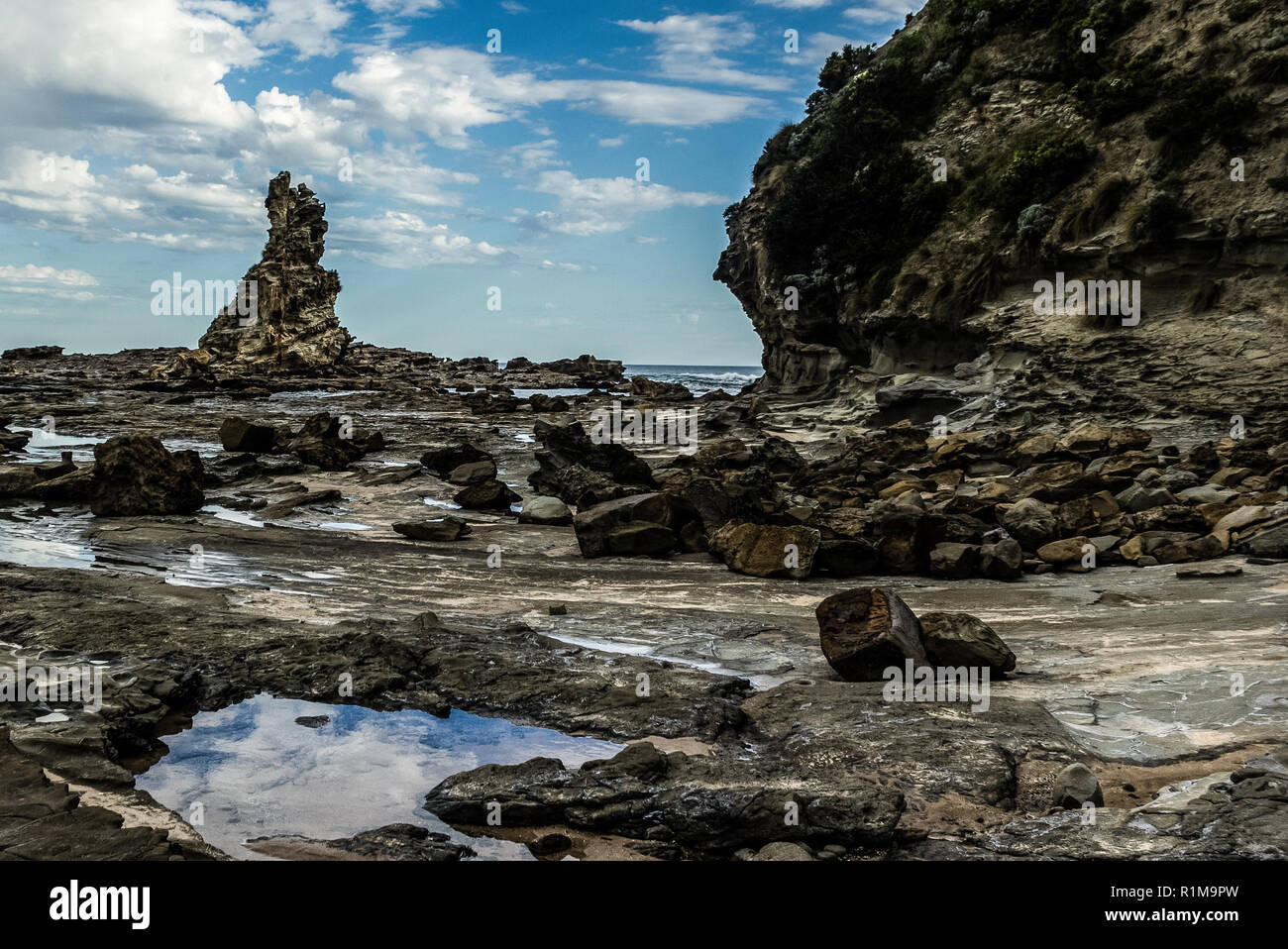 sharp and rough cliff rocks emerging from the water of the Australian ...