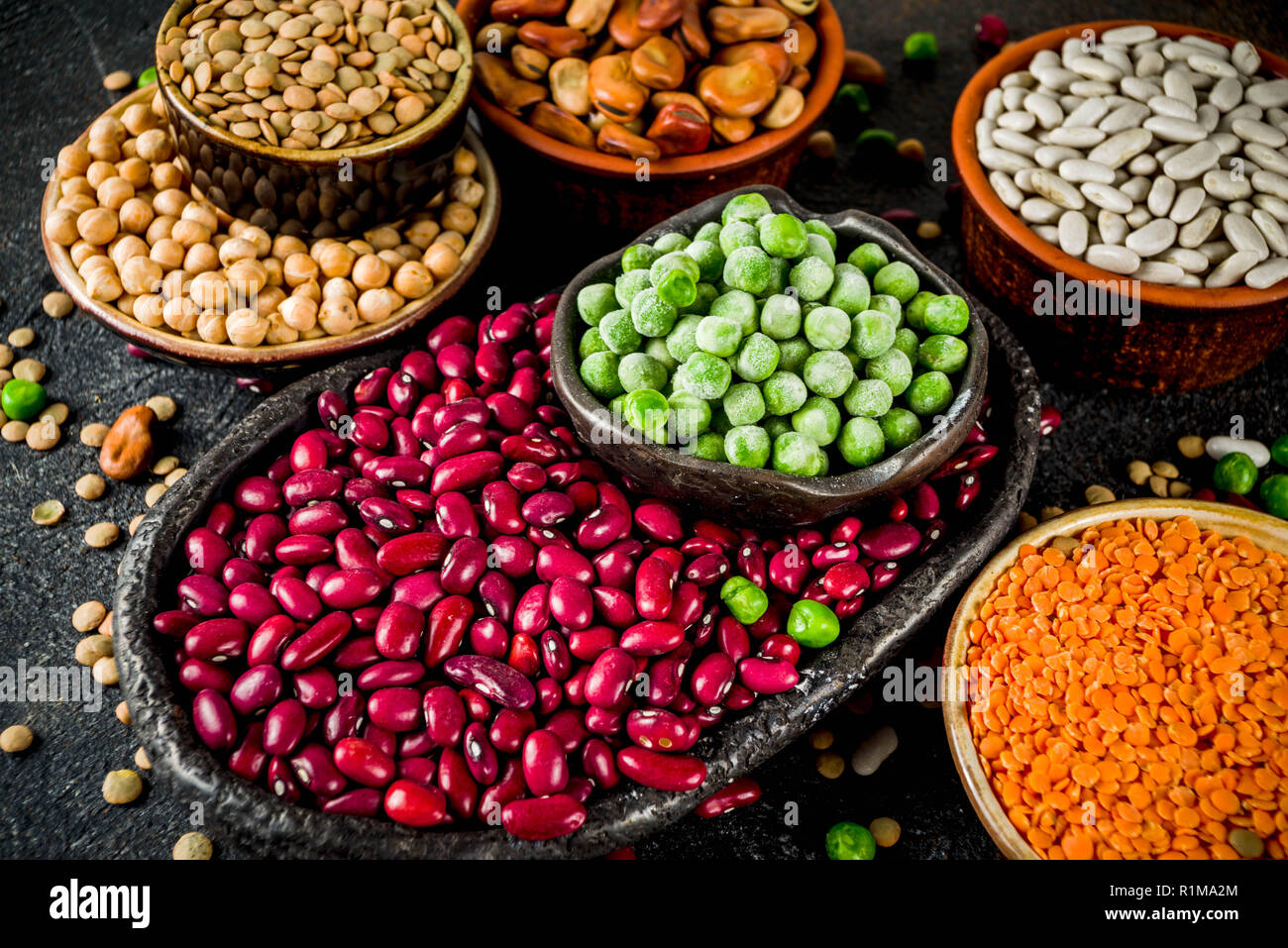 Various assortment of legumes - beans, soy beans, chickpeas, lentils ...