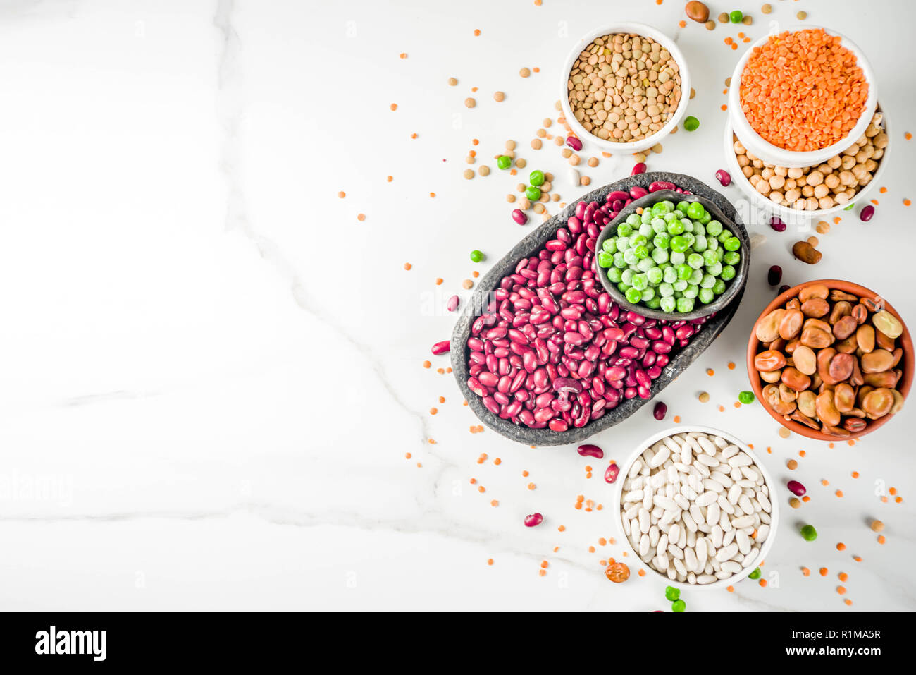 Various assortment of legumes - beans, soy beans, chickpeas, lentils ...
