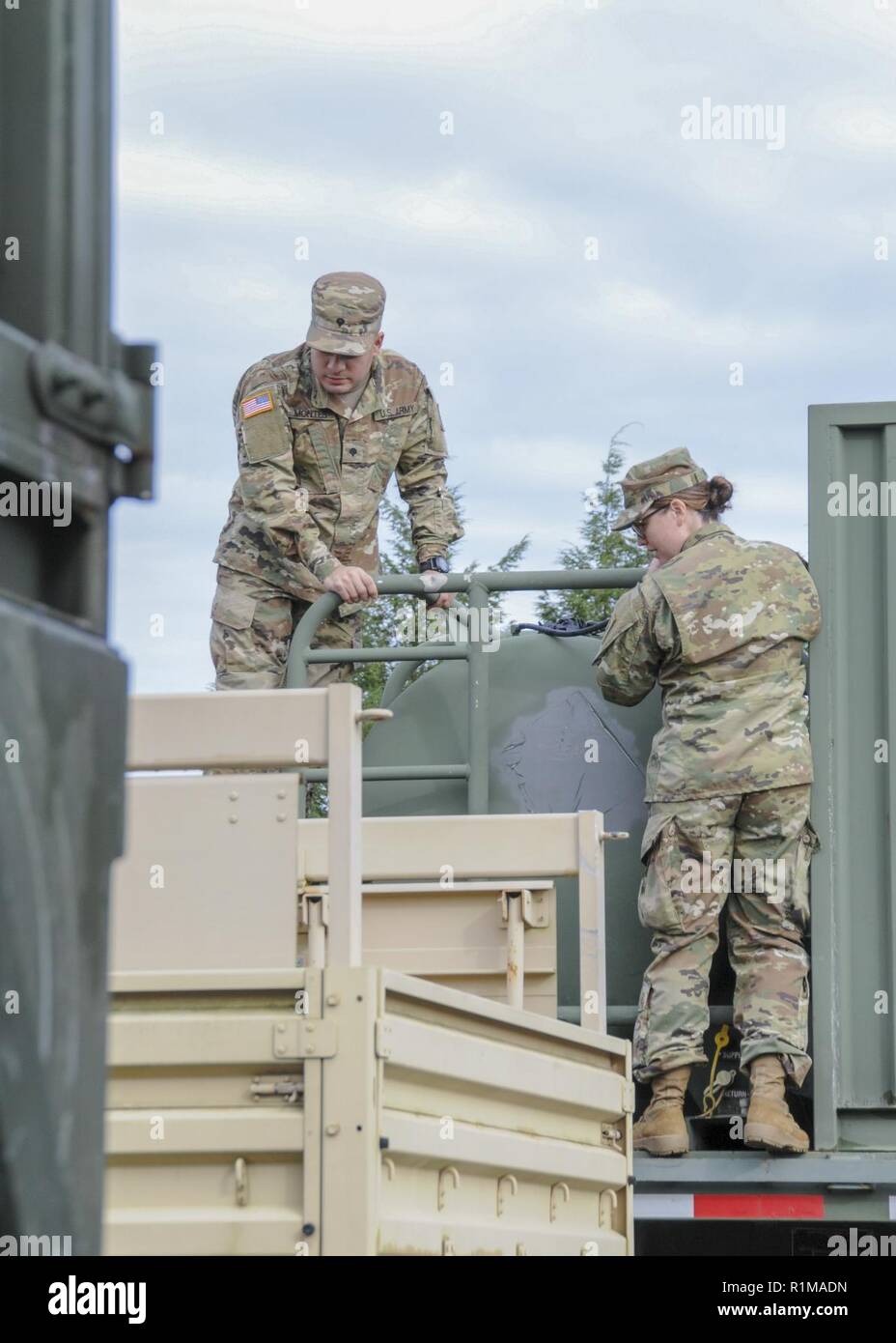 U.S. Army Reserve Soldiers conduct vehicle maintenance prior to moving ...