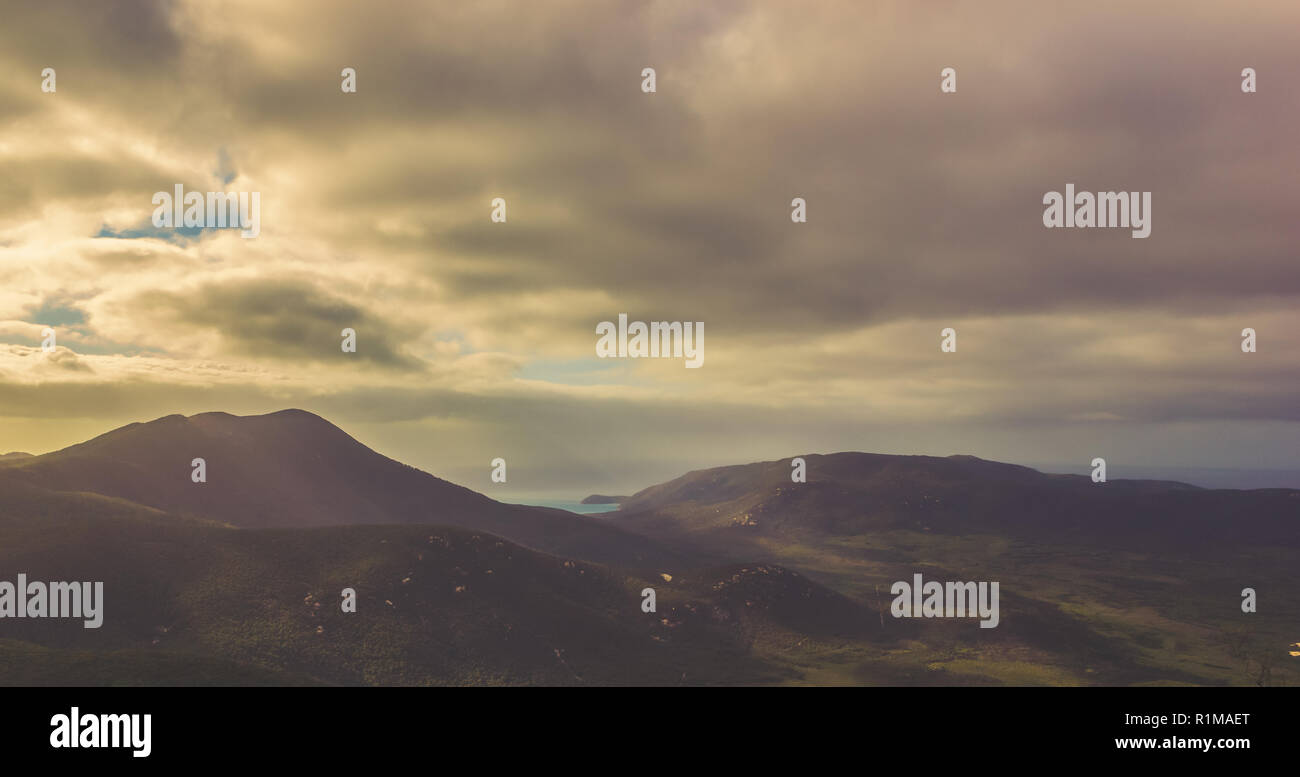 sun shining through the clouds at Mount Oberon Summit at sunset ...