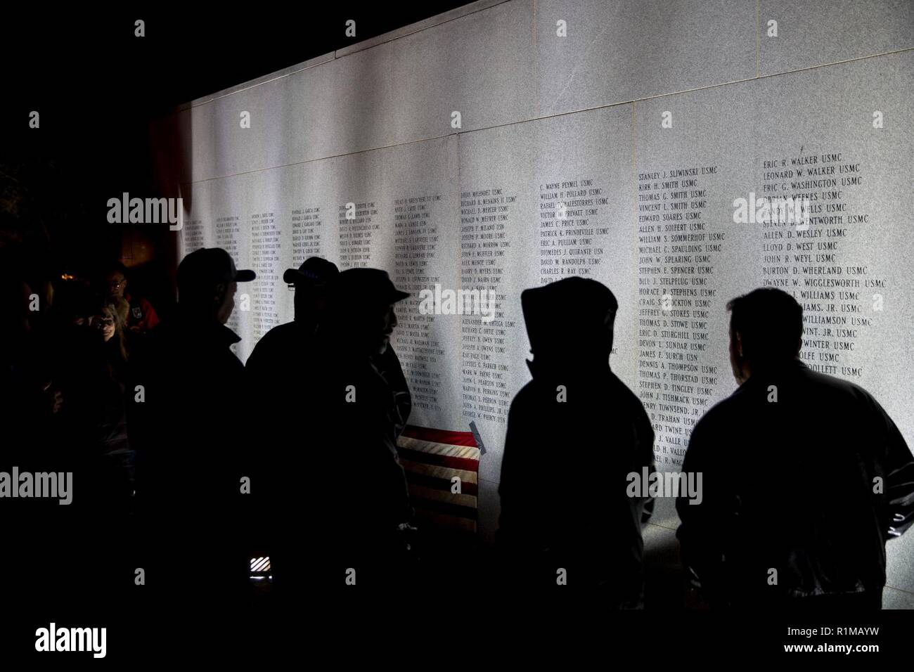 Service members, veterans and families attend a candlelight vigil ...