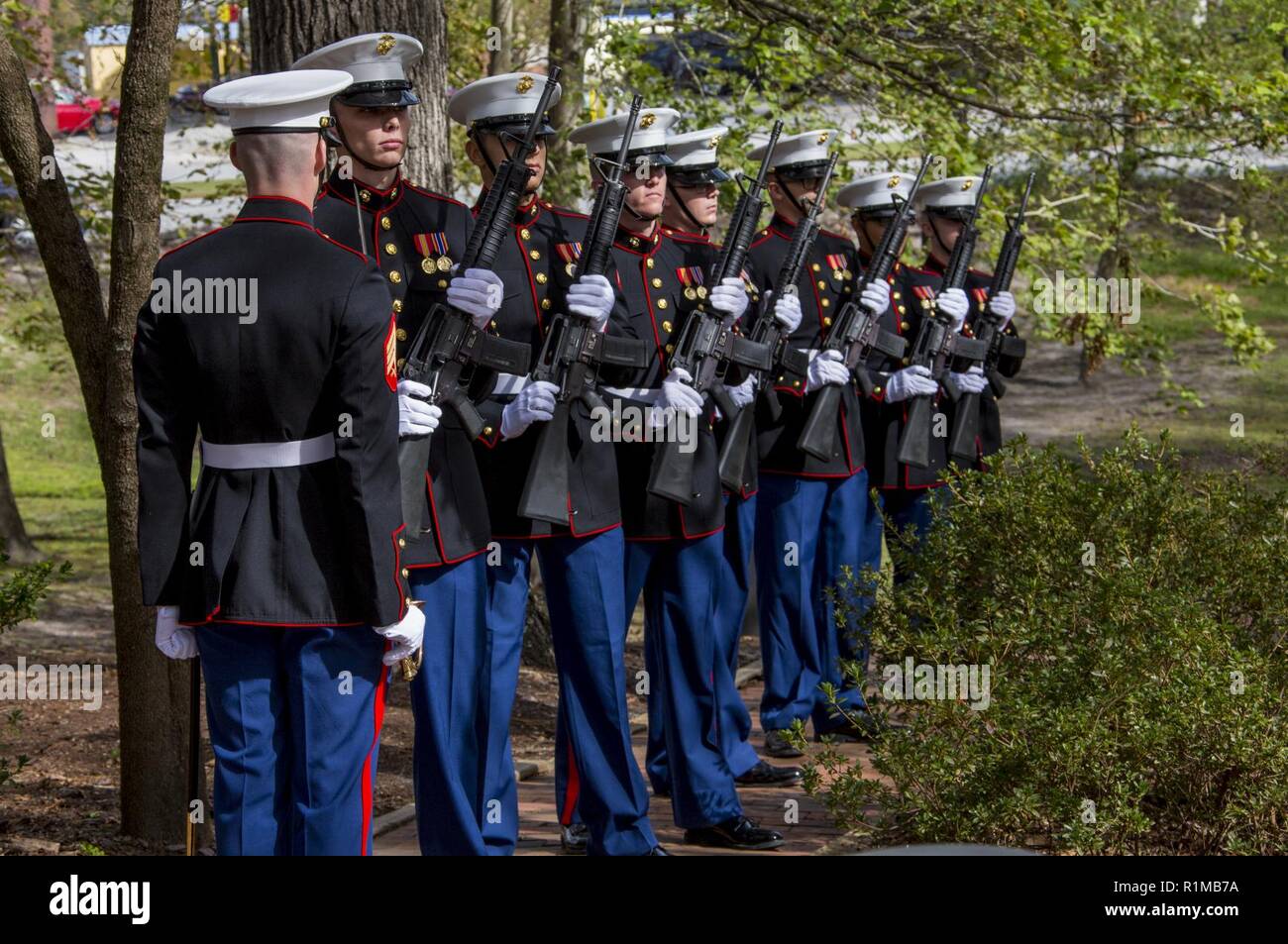 A rifle detail from 8th Marine Regiment stand at port arms, during the ...