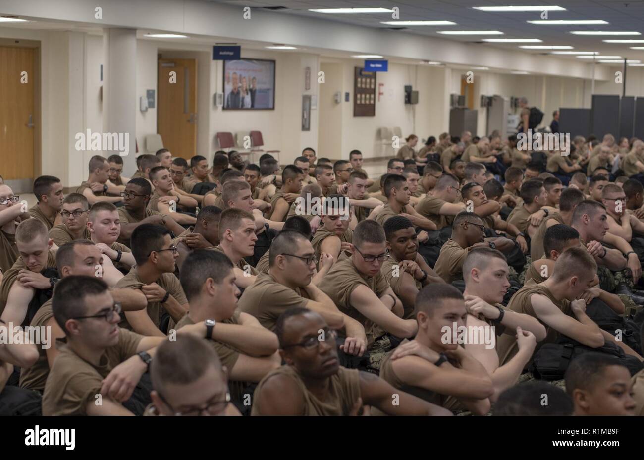 GREAT LAKES, Ill. (Oct. 23, 2018) Recruits roll up their sleeves while ...