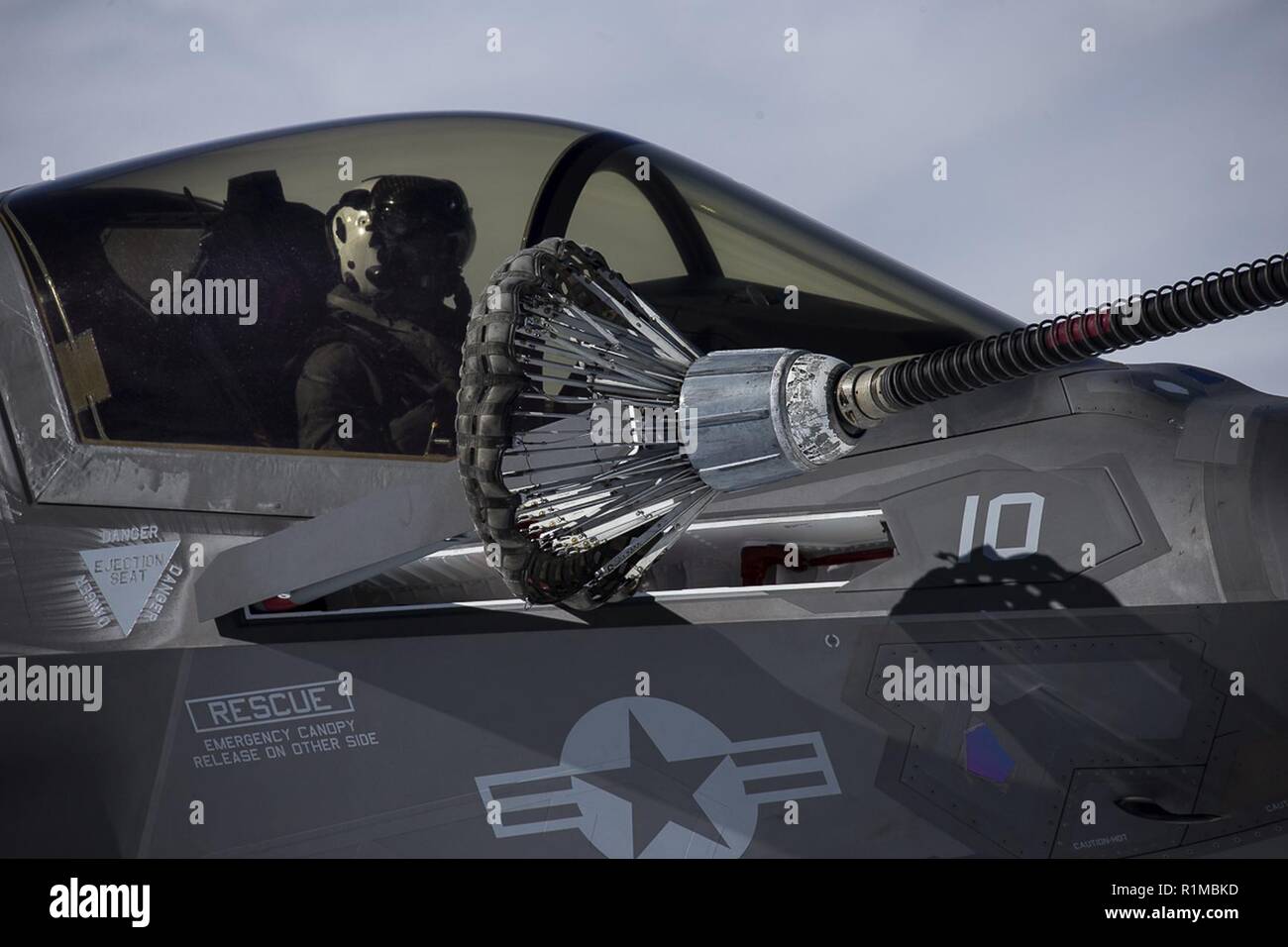 An F-35B Lightning II attack jet flies alongside a KC-130J tanker ...