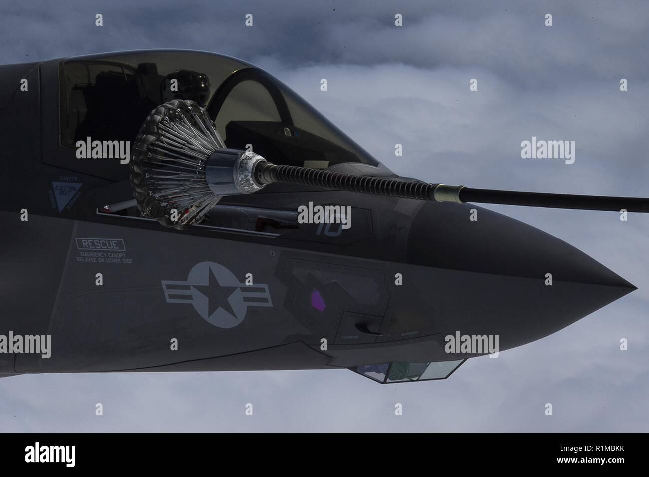 An F-35B Lightning II attack jet flies alongside a KC-130J tanker ...