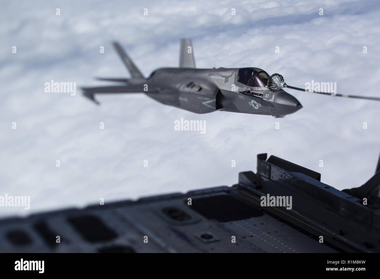 An F-35B Lightning II attack jet flies alongside a KC-130J tanker ...