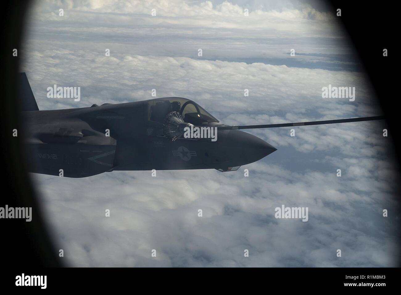 An F-35B Lightning II attack jet flies alongside a KC-130J tanker ...