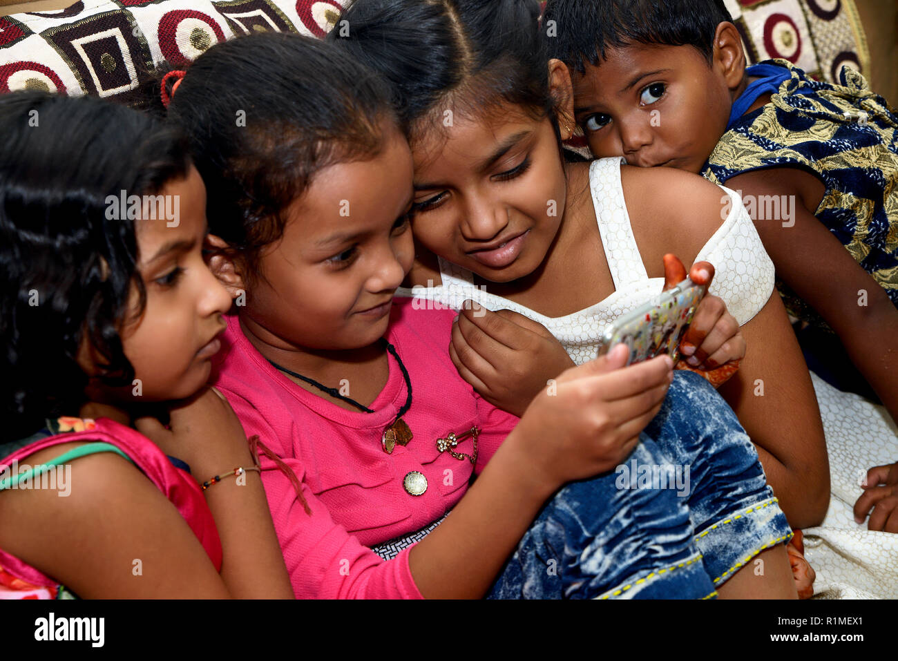 Group of children using smart phone Stock Photo - Alamy