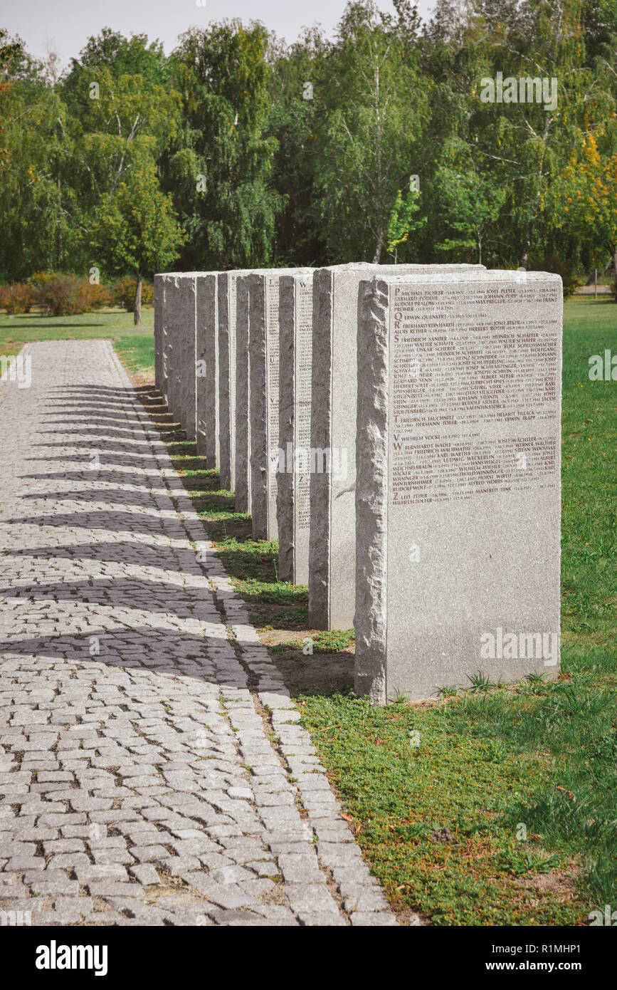 old memorial gravestones with lettering placed in row and trees at ...