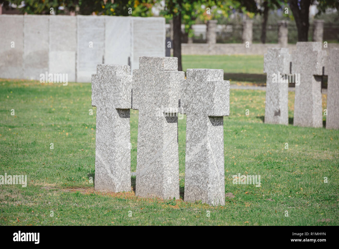 stone memorial monuments placed in row on grass at cemetery Stock Photo ...