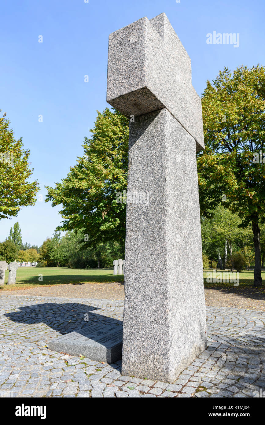 low angle view of memorial tombstone in shape of cross at graveyard ...