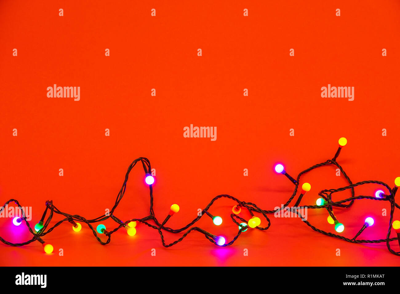 Christmas lights over red background. Colorful border with empty copy ...