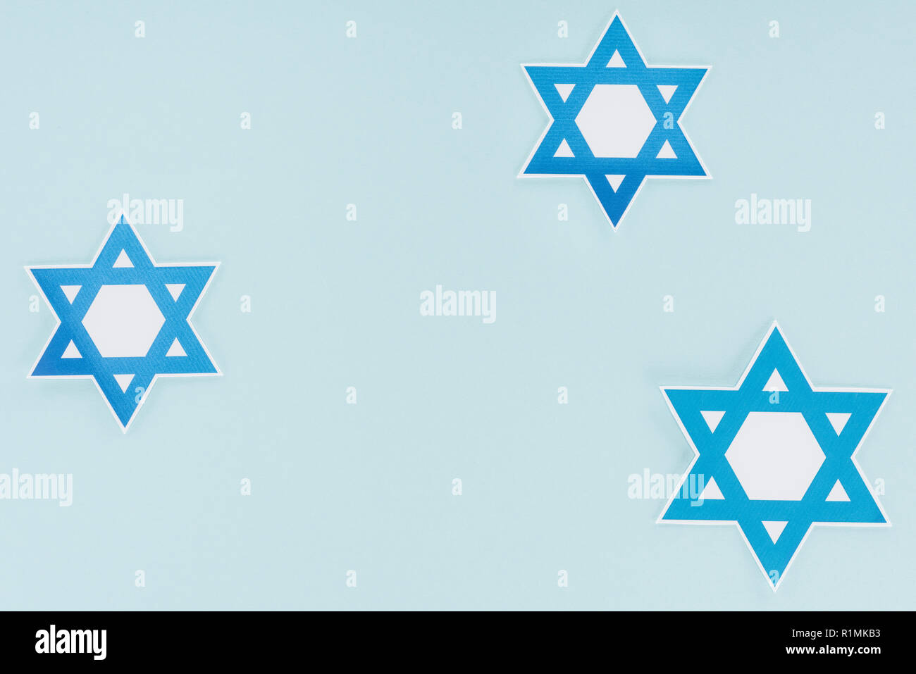 flat lay with traditional jewish stars isolated on blue, hannukah ...