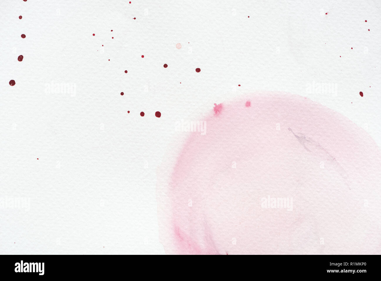abstract light pink watercolor painting with splatters on white paper ...