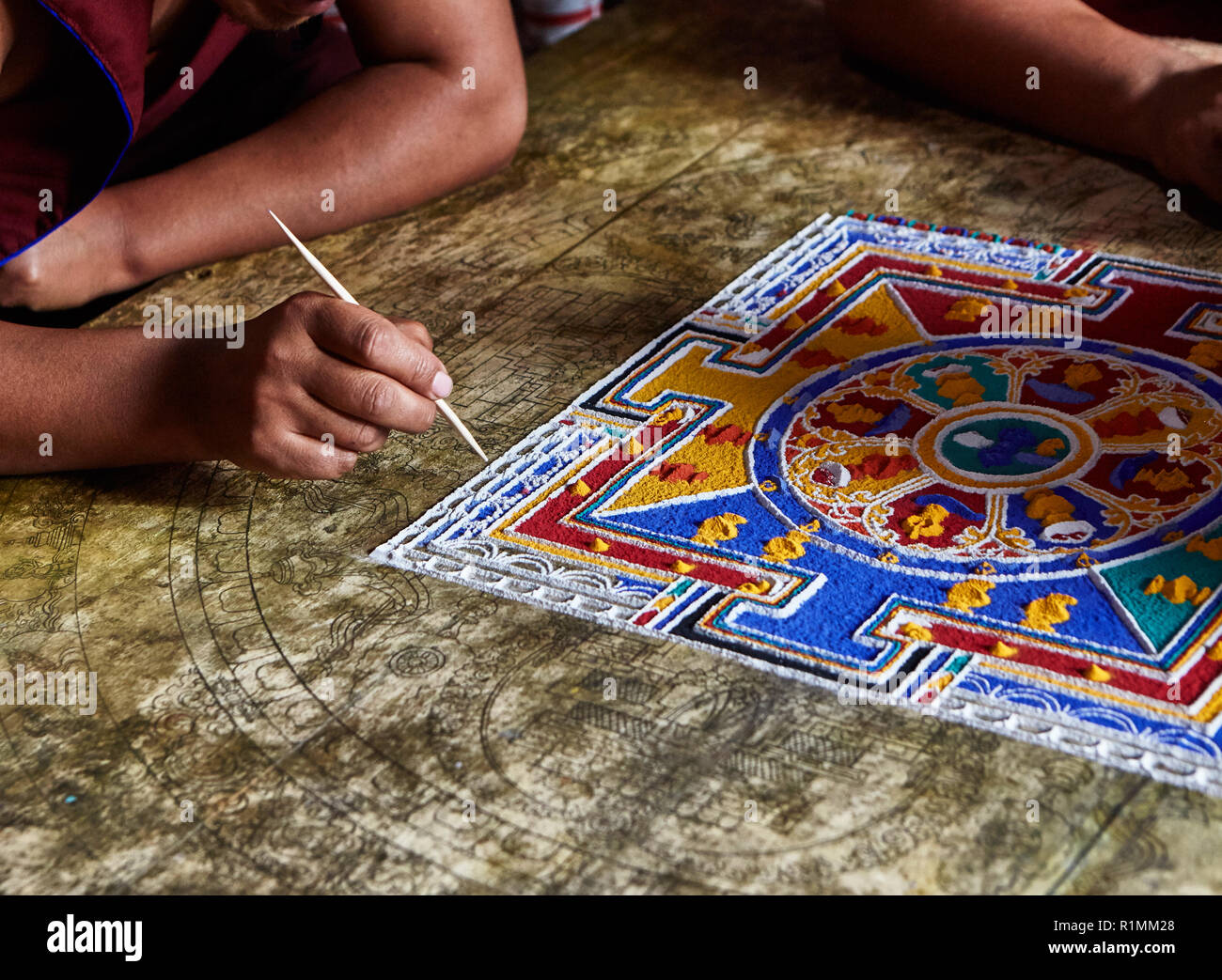Buddhist monks creating a mandala of colored sand in Lamayuru monastery ...