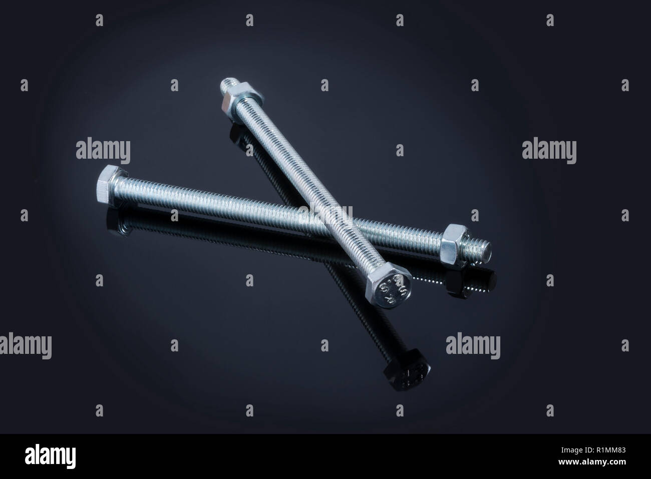 Bolts And Nut On Black background with reflection Stock Photo - Alamy