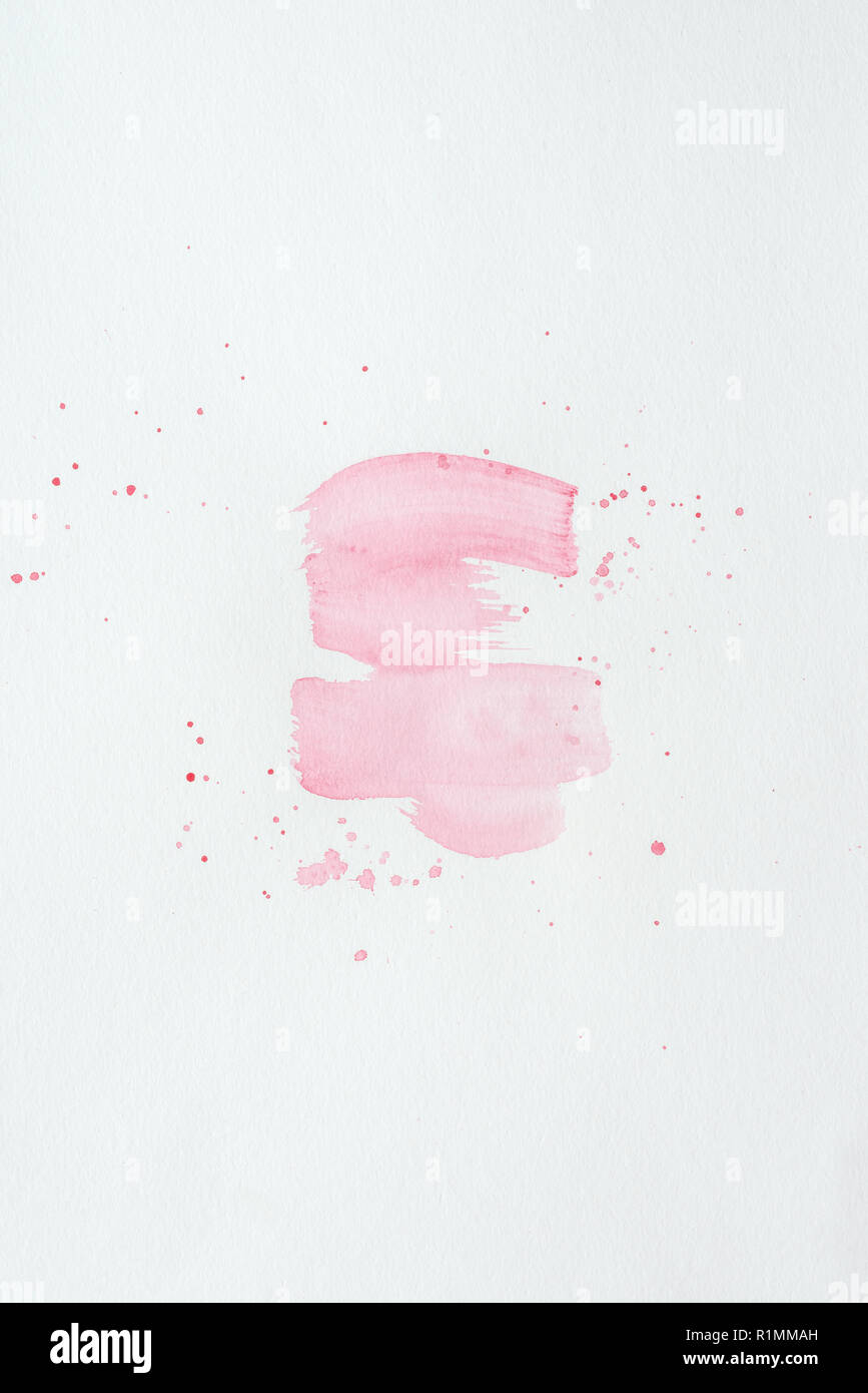abstract light pink watercolor strokes with splatters on white paper ...