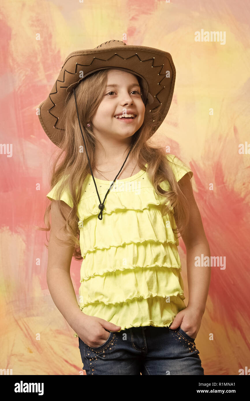 beautiful little girl in fashion cowboy hat has smiling happy face on ...