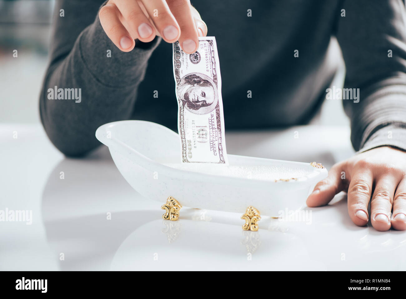 partial view of man washing dollar banknote in small bathtub, money ...