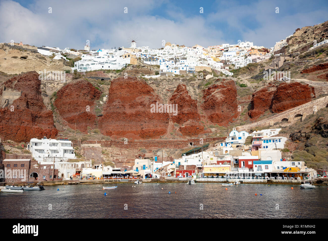 Oia, Greece - 18.11.2018: View of Oia village with white houses on red ...